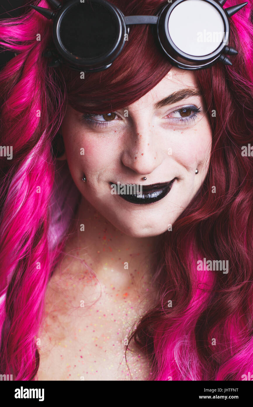 Young woman with pink hair and steampunk look Stock Photo - Alamy