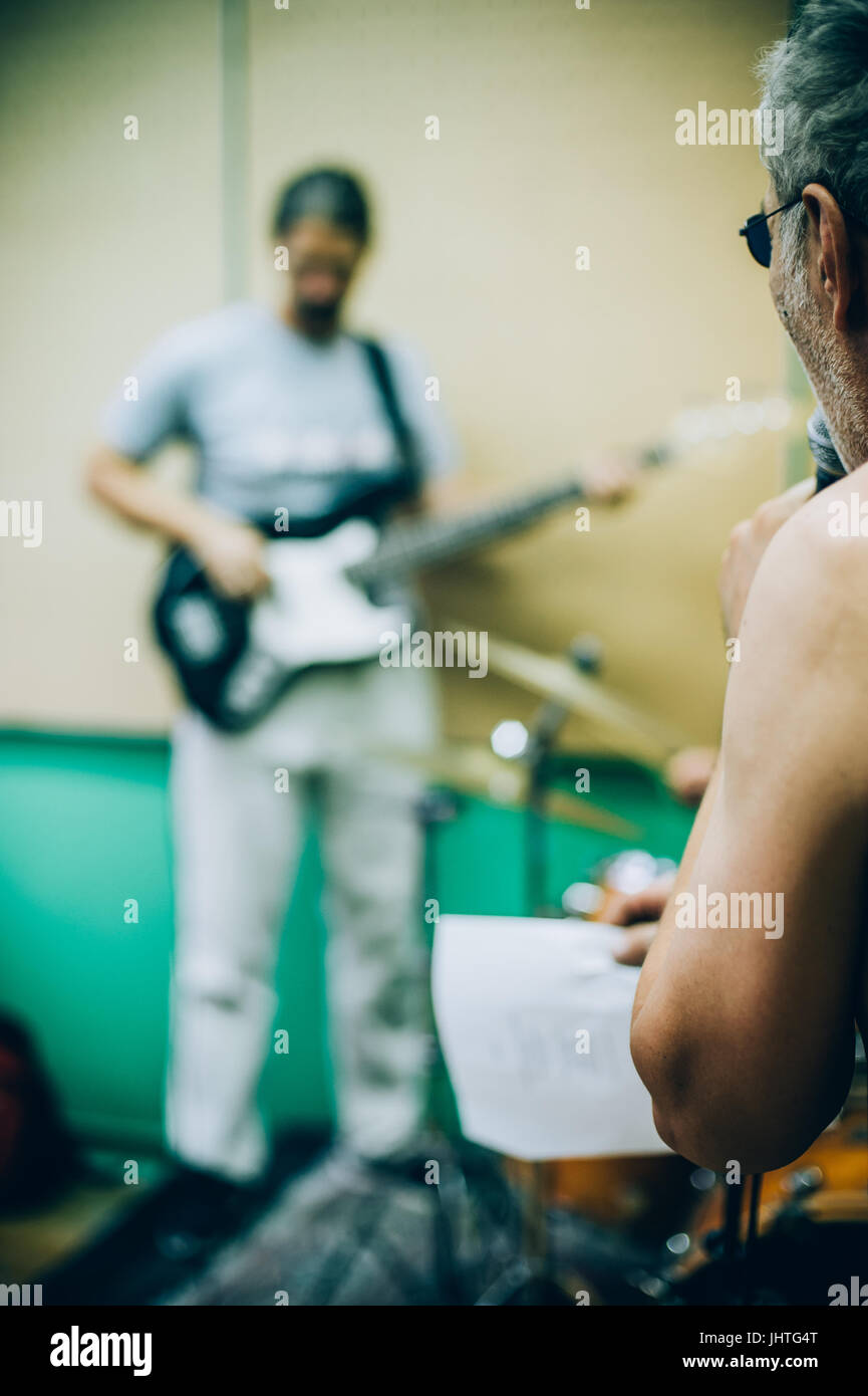 Behind the scene. Rock band practice in the messy recording music ...