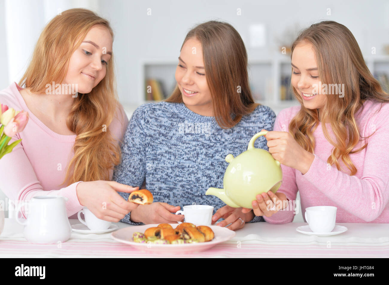Teenage girls drinking tea Stock Photo - Alamy