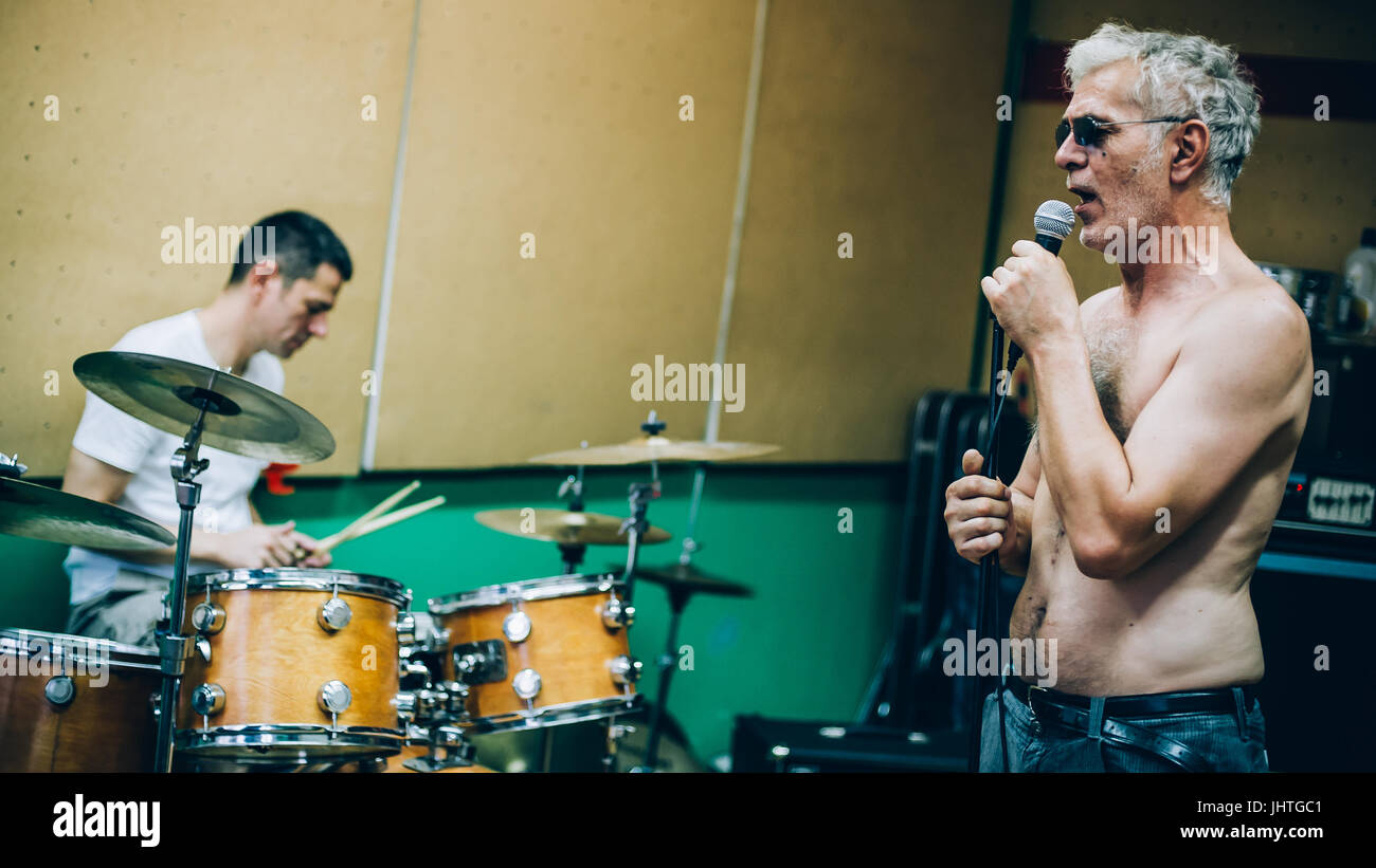 Behind the scene. Rock band practice in the messy recording music ...