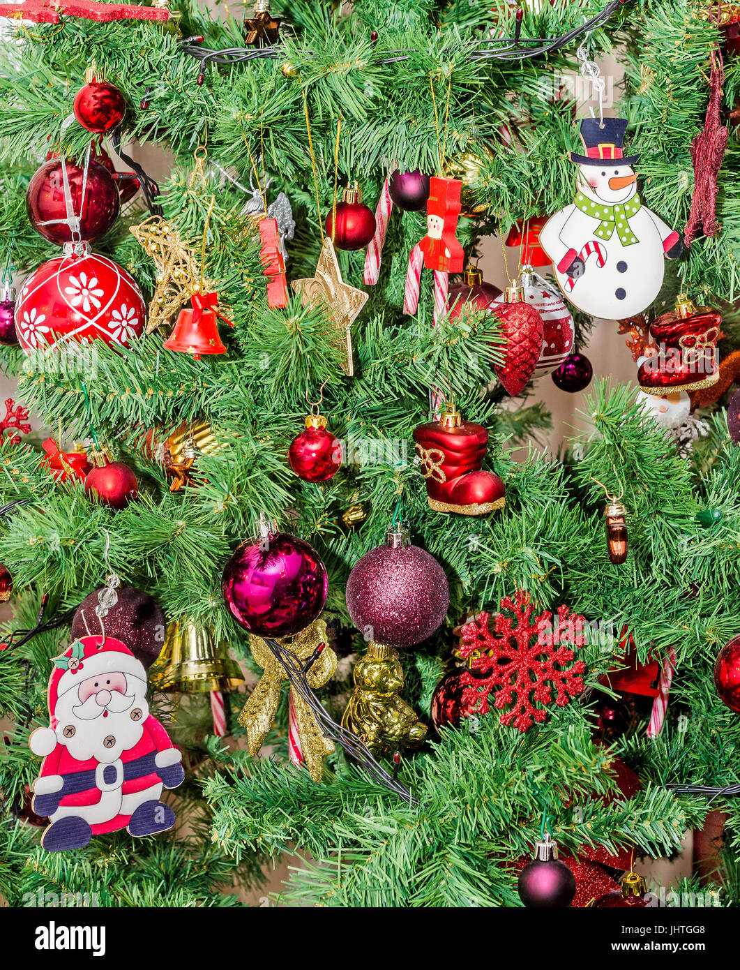 Detail of green Christmas (Chrismas) tree with colored ornaments ...
