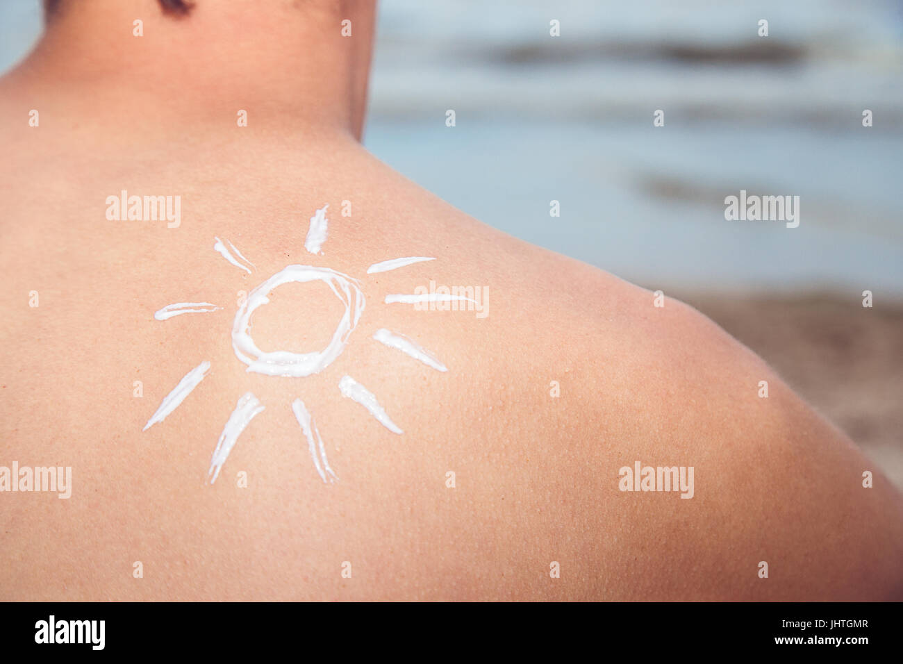 Lotion man with sunscreen with sun over sea background Stock Photo - Alamy