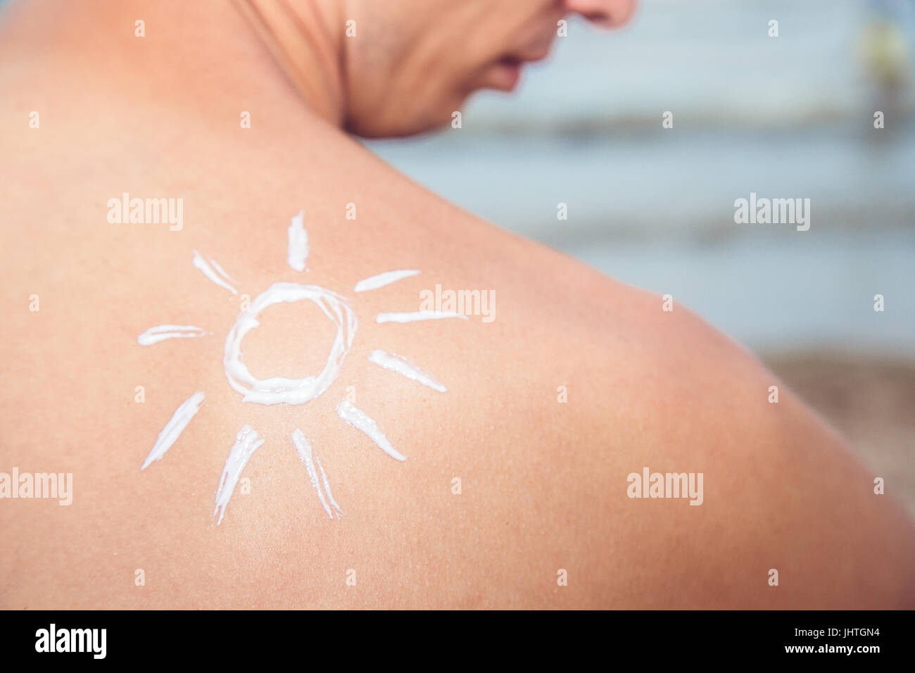 Lotion man with sunscreen with sun over sea background Stock Photo - Alamy
