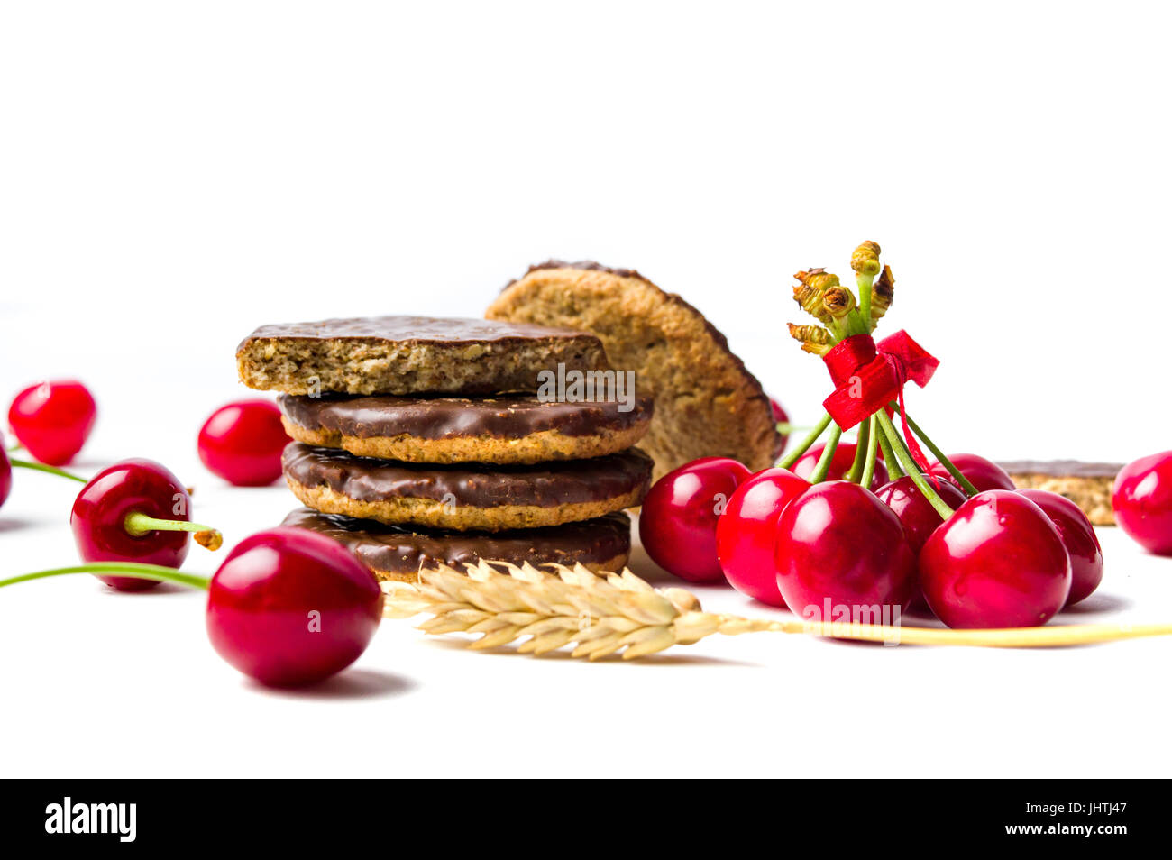 Cherry biscuits and fruits isolated on white Stock Photo - Alamy
