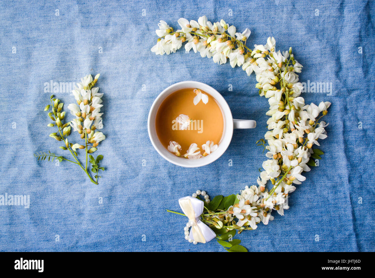 Acacia herbal tea and flowers top view Stock Photo - Alamy