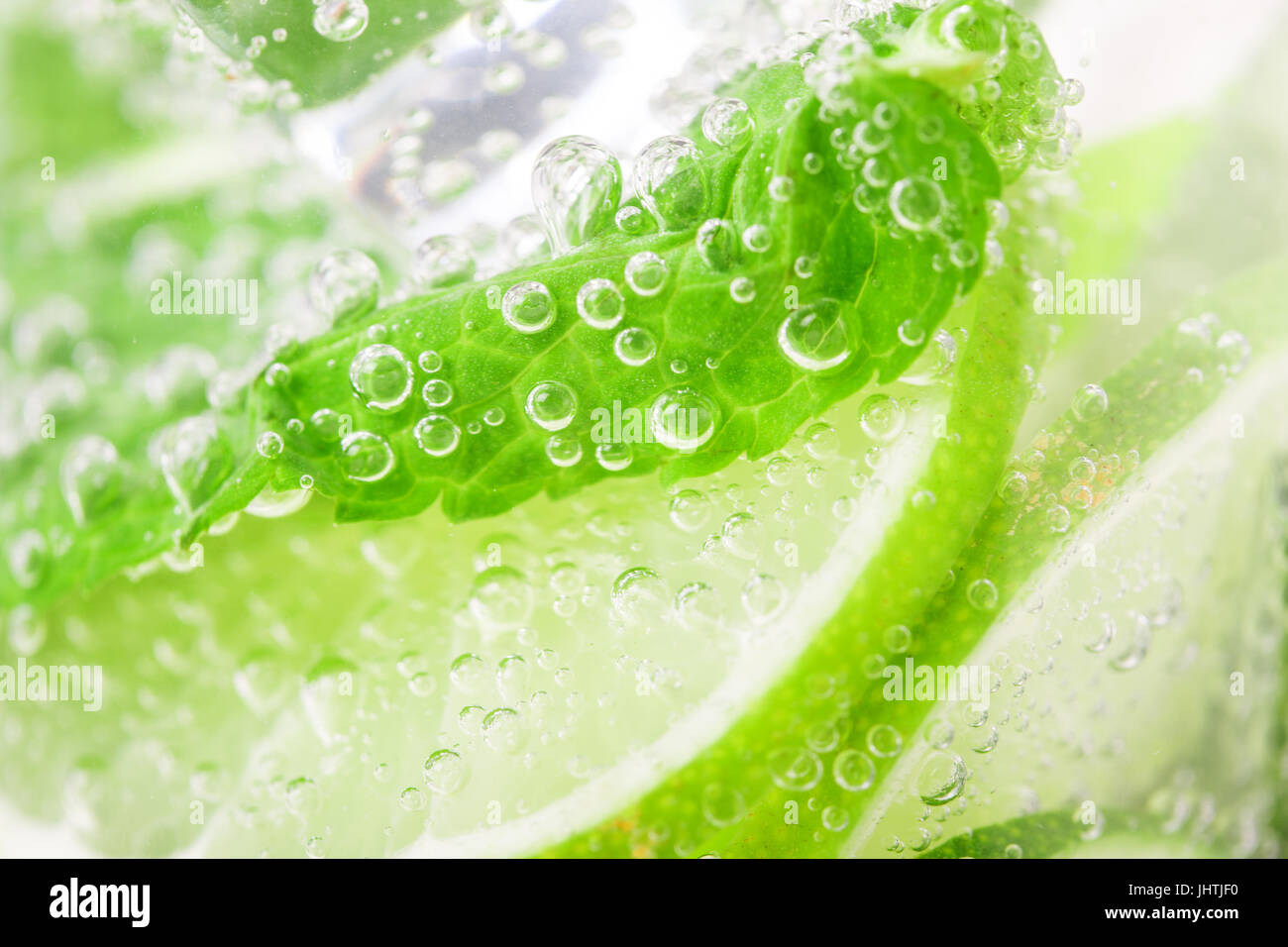 Detox water with lime and mint in glass. Mojito cocktail. on a white ...