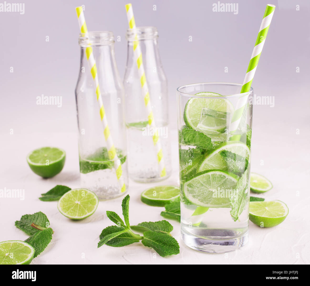 Detox water with lime and mint in glass. Mojito cocktail. on a white ...