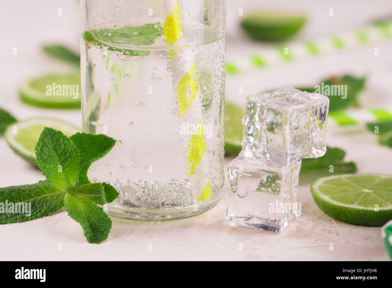 Detox water with lime and mint in glass. Mojito cocktail. on a white ...