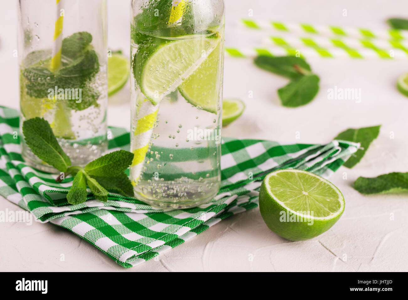 Detox water with lime and mint in glass. Mojito cocktail. on a white ...