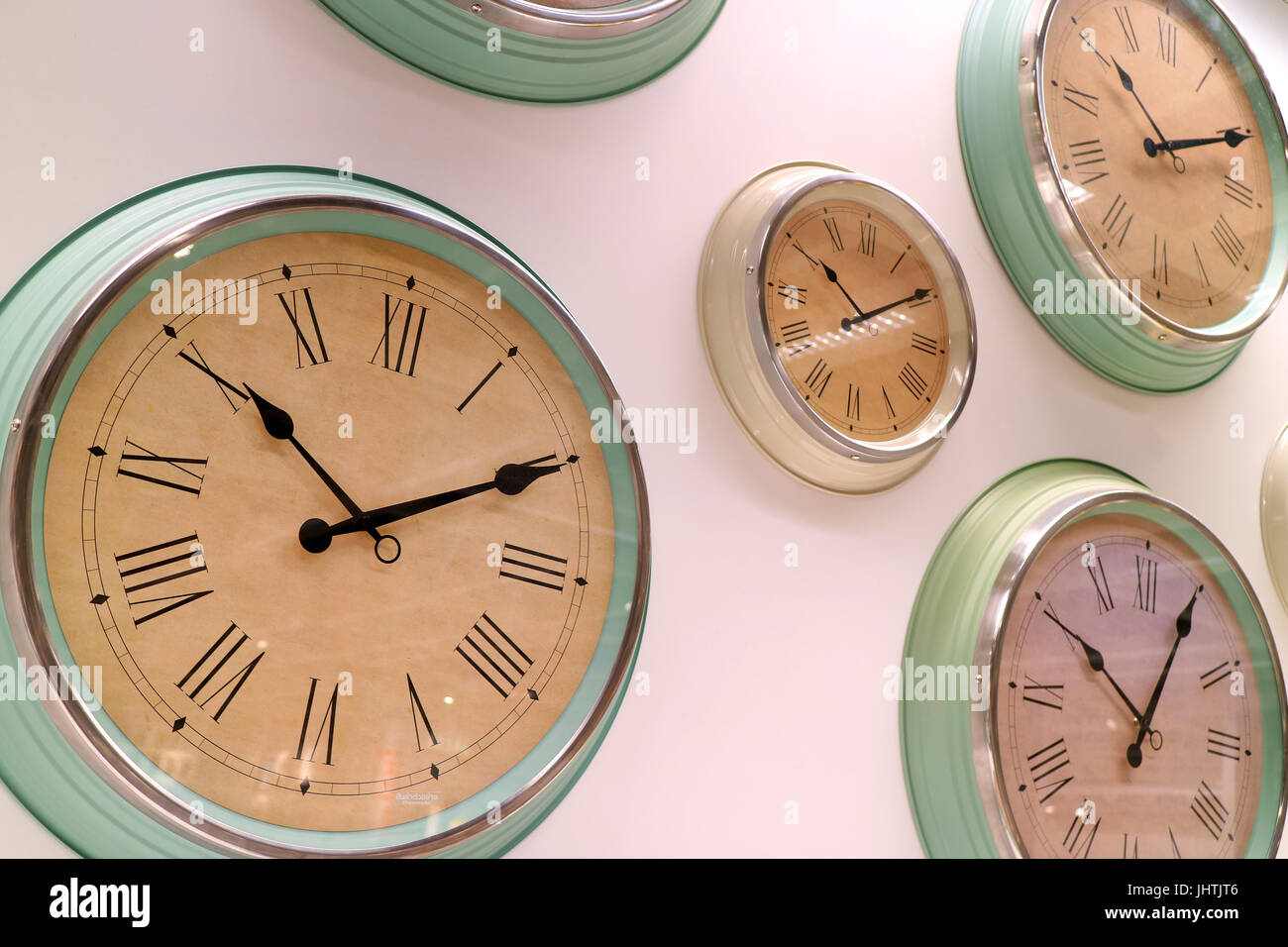 Different type of retro style wall clocks on the wall Stock Photo - Alamy