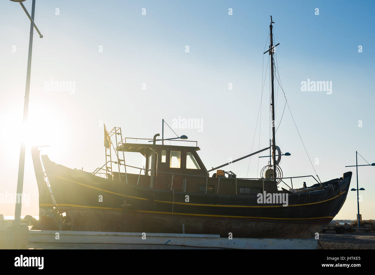 Small ship at sunset Stock Photo - Alamy