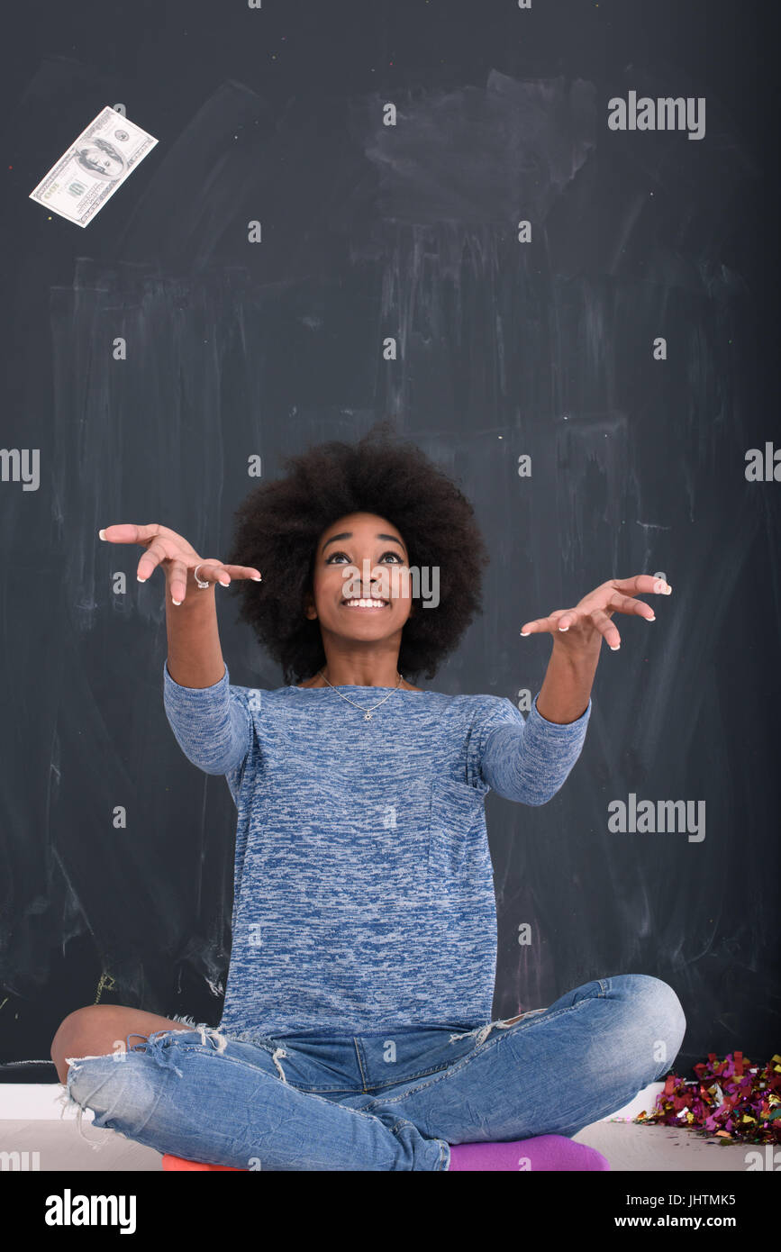 beautiful smiling afro american woman throwing money isolated on a gray ...