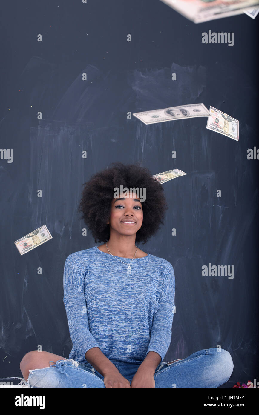 beautiful smiling afro american woman throwing money isolated on a gray ...