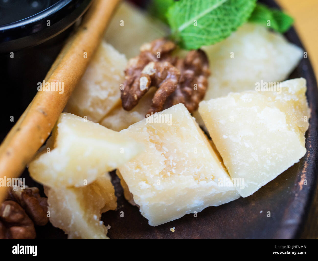 Italian chesse plate on black dish Stock Photo - Alamy