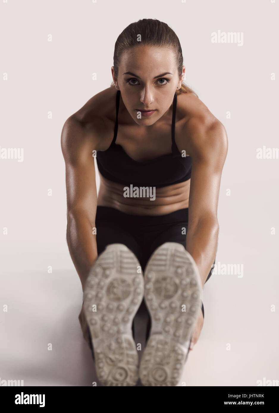 Shot of a young woman doing stretching exercises Stock Photo - Alamy