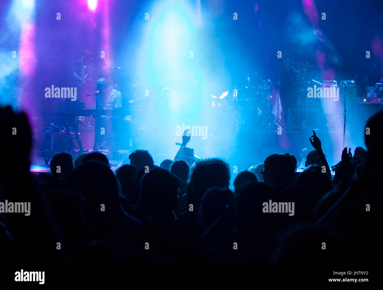 Photo of many people enjoying concert, crowd with raised up hands ...