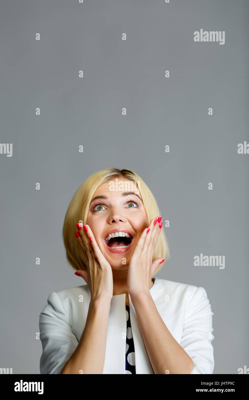 Surprised happy girl looking up Stock Photo - Alamy