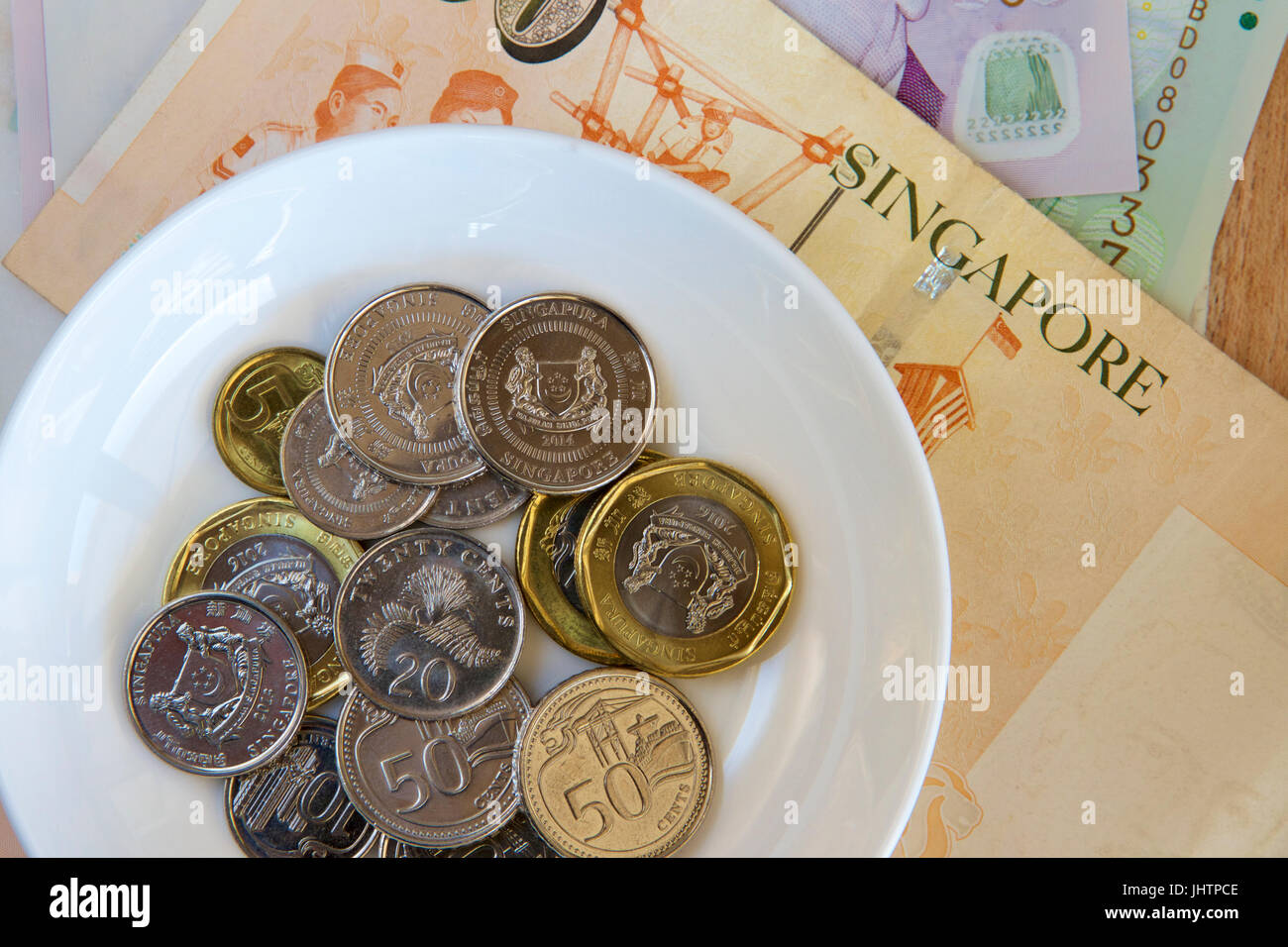 Singaporean coins on a plate with notes Stock Photo - Alamy