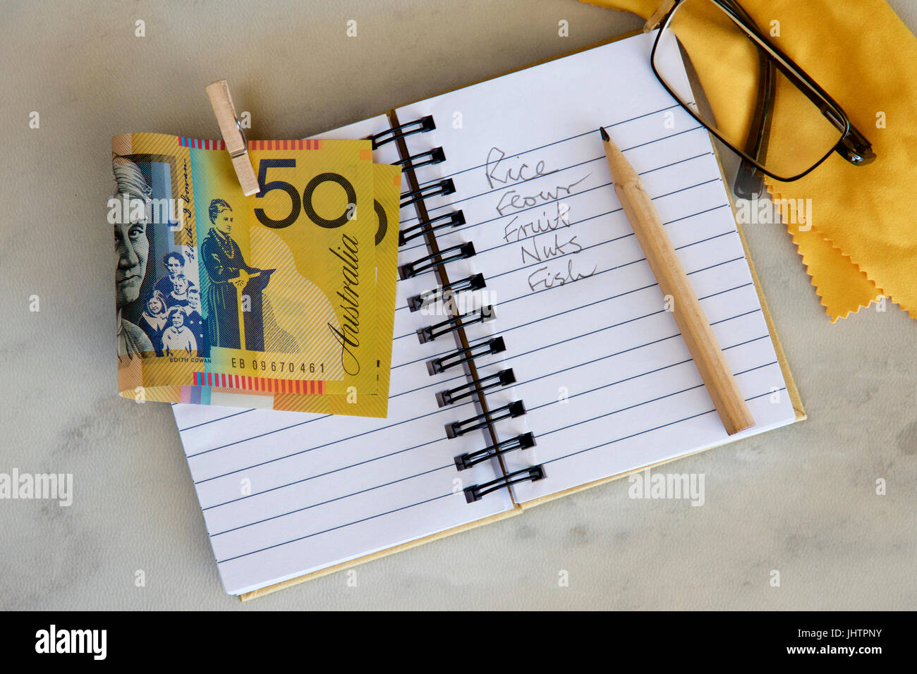 Australian dollars and a shopping list in a notebook Stock Photo - Alamy