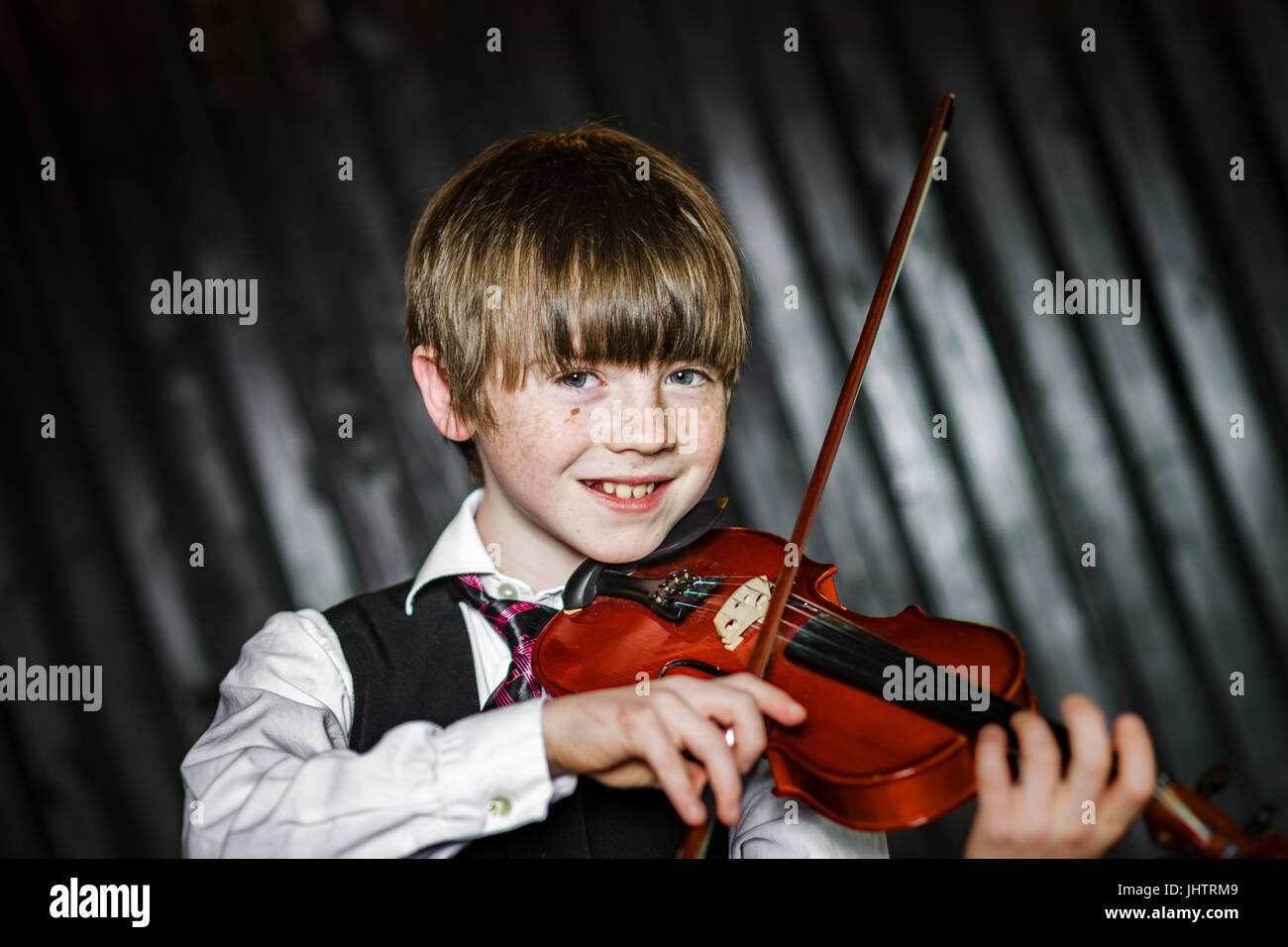 Attractive boy playing violin, studio shooting, music concept Stock ...