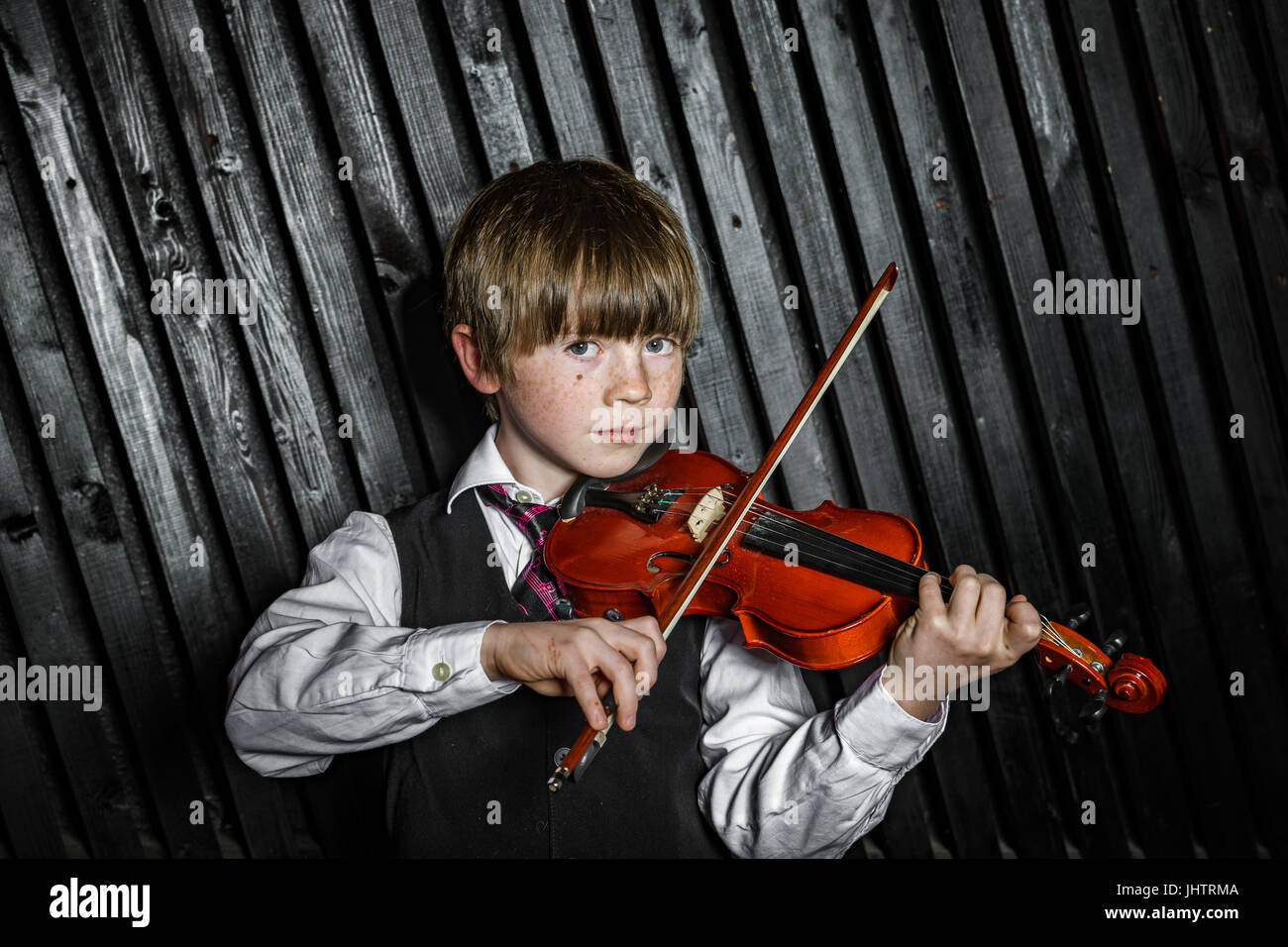 Attractive boy playing violin, studio shooting, music concept Stock ...