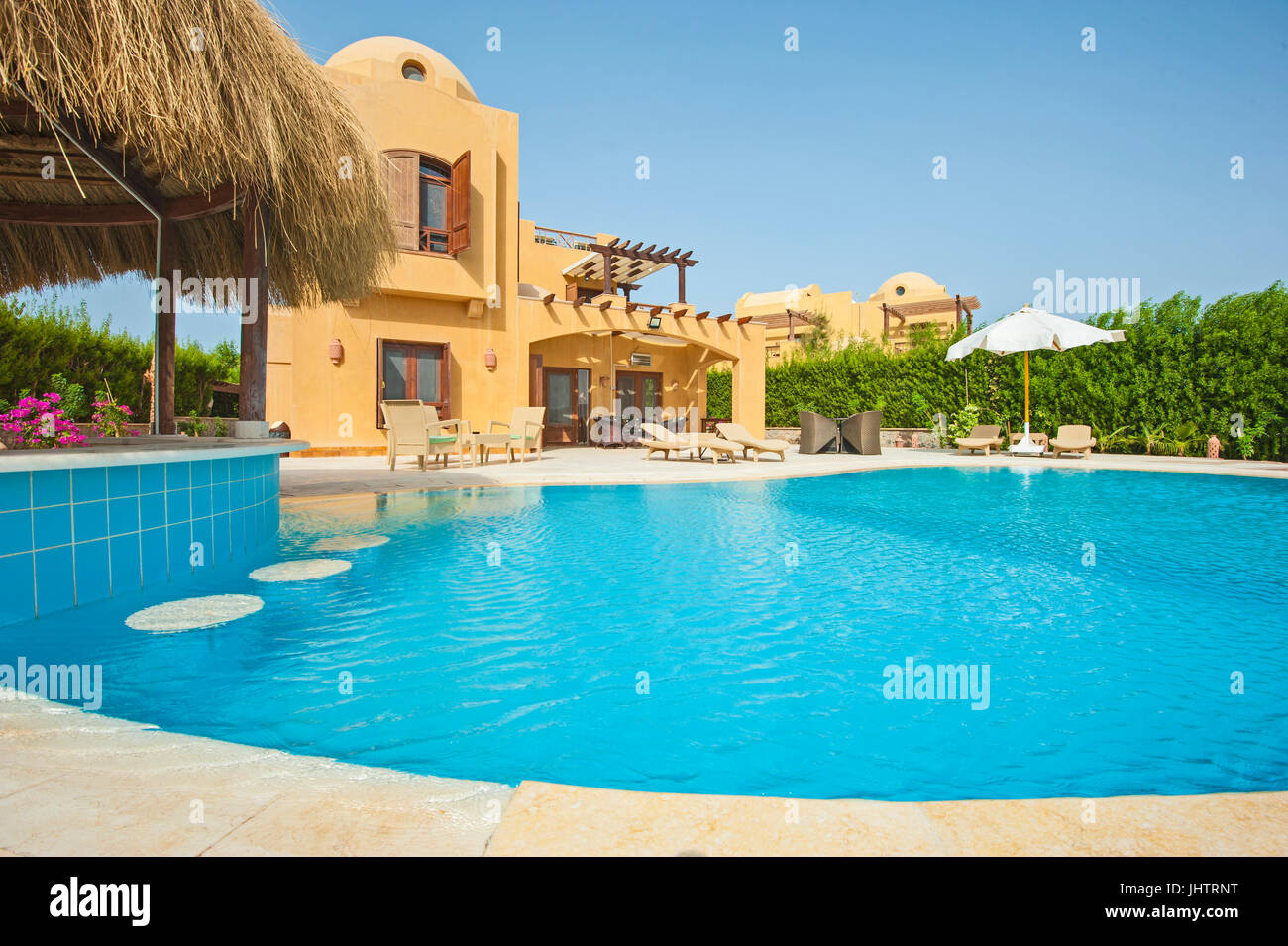 Luxury villa show home in tropical summer holiday resort with swimming ...