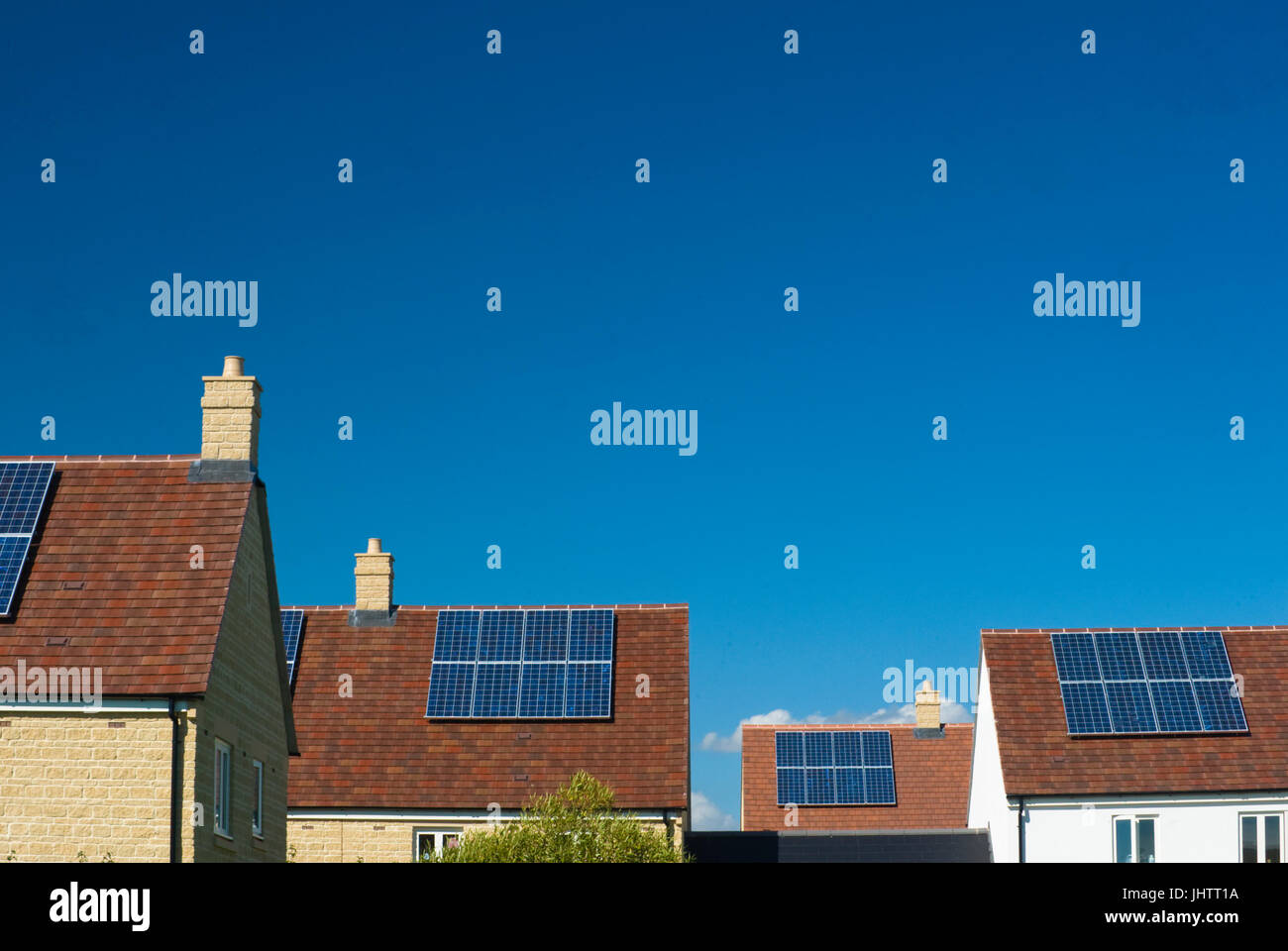 Solar panels fitted to the roofs of domestic houses during construction ...