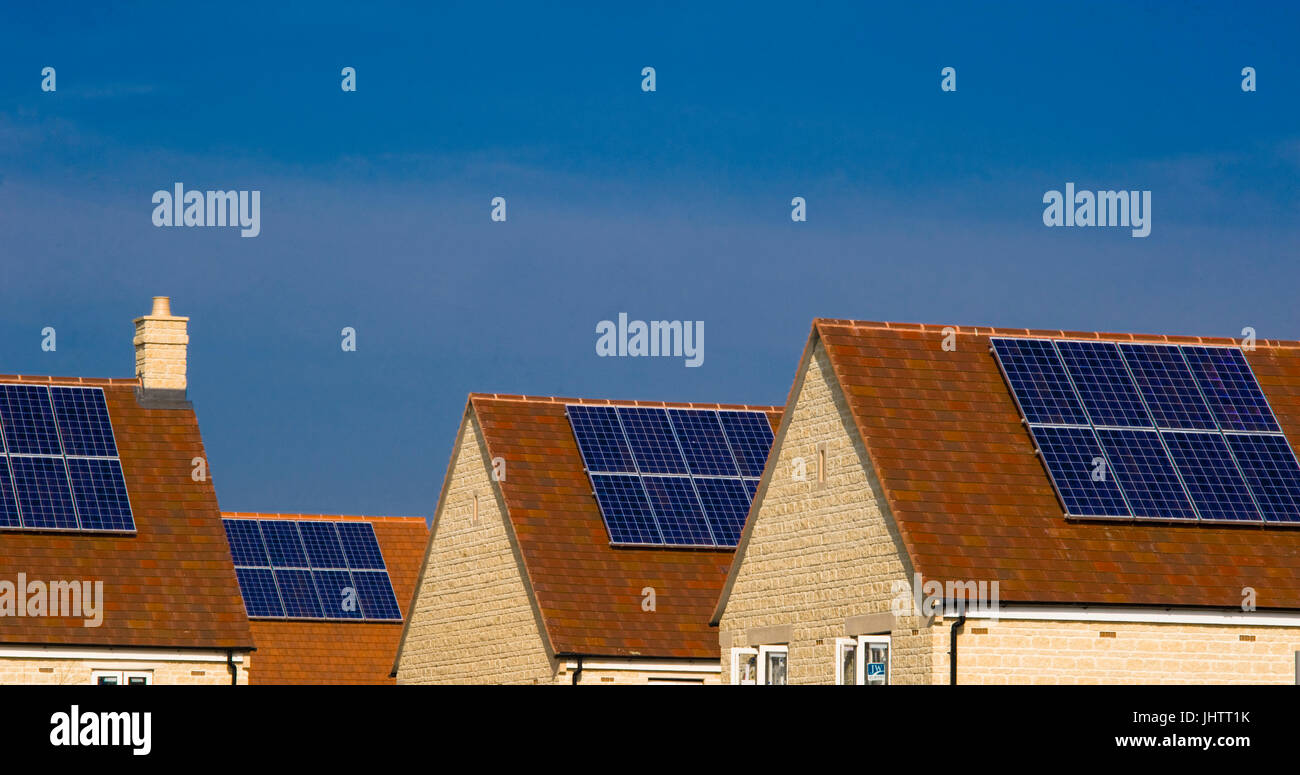 Solar panels fitted to the roofs of domestic houses during construction ...
