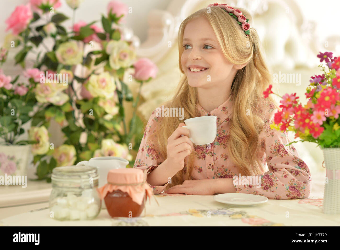 Cute girl drinking tea Stock Photo - Alamy