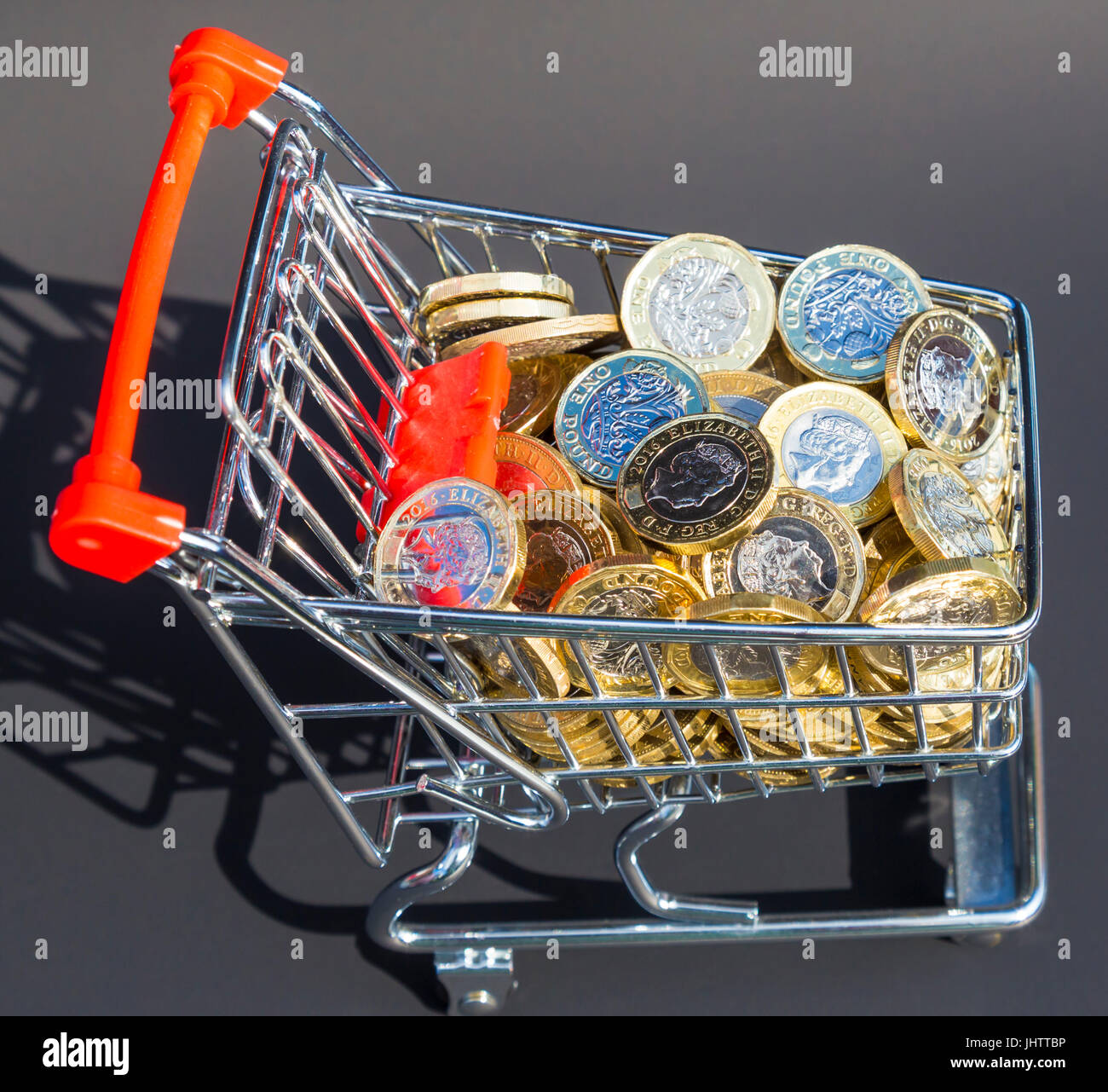 Shopping basket full on new one pound coins Stock Photo - Alamy