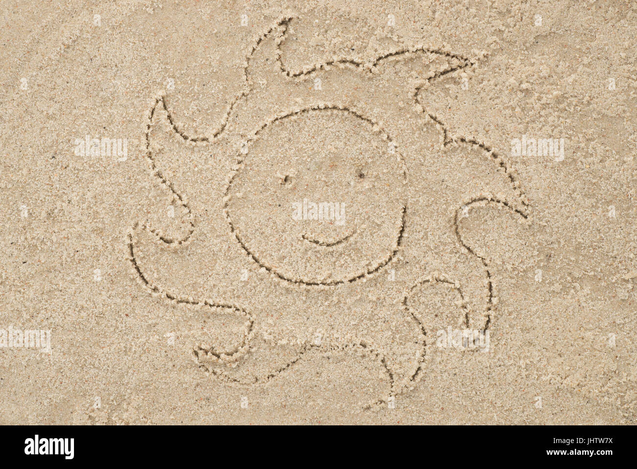 sun drawing in sand background Stock Photo - Alamy