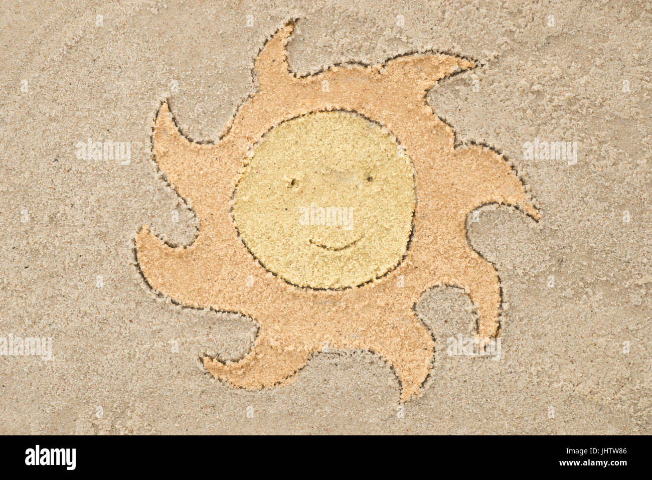 sun drawing in sand background Stock Photo - Alamy