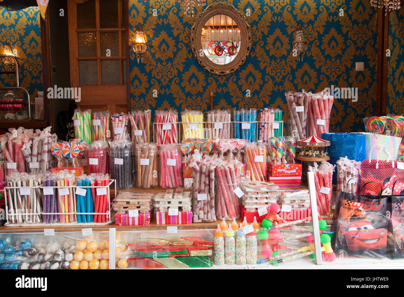 Different colors candy and candy canes in a candy stall at the fair ...
