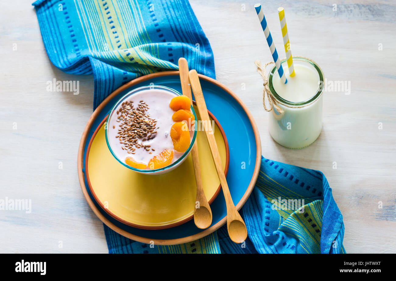 Healthy breakast corn flakes in a bowl and glass of milk on rustic ...