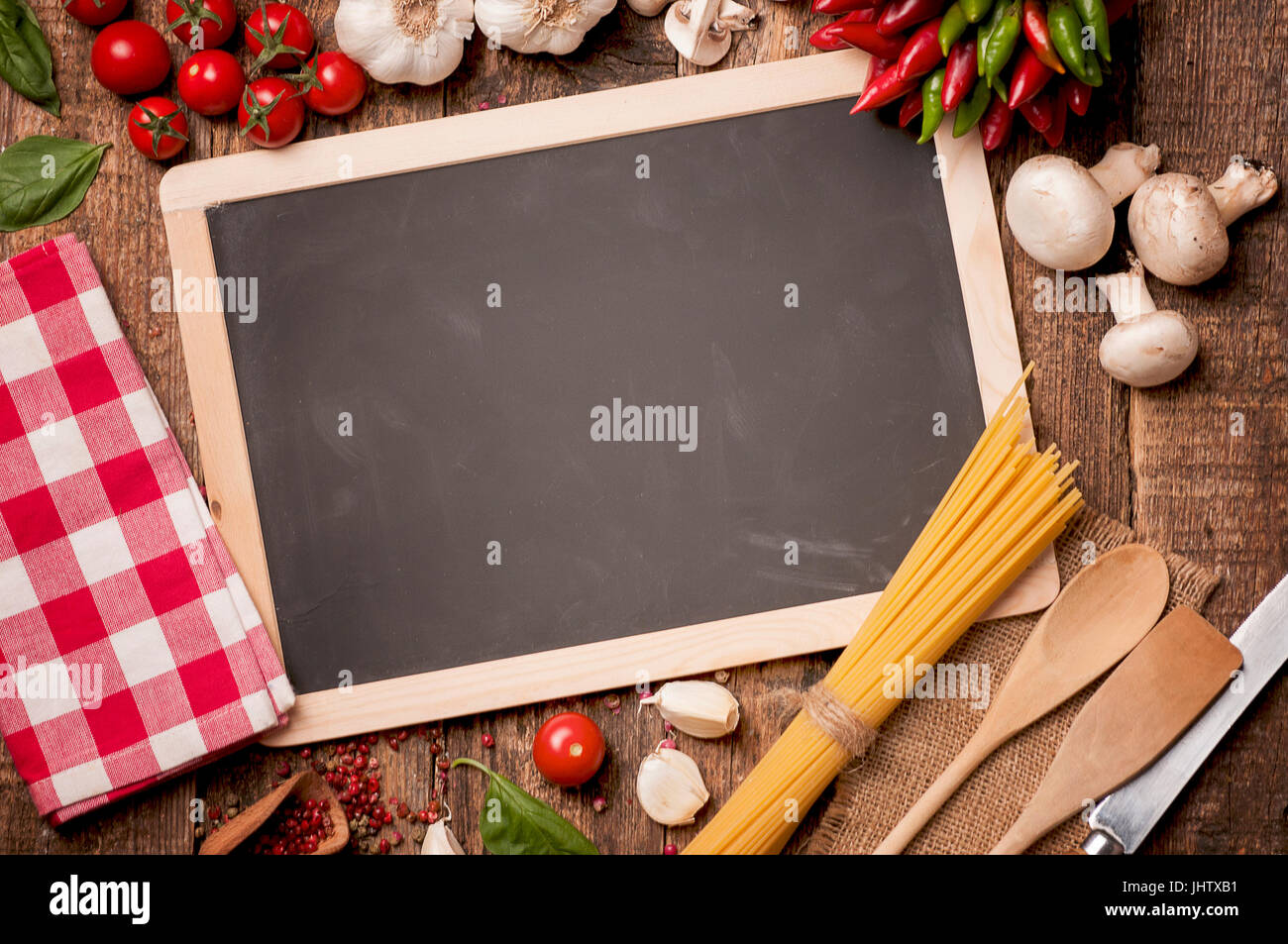 Pasta cooking background with chalkboard, tomatoes, basil and olive oil ...