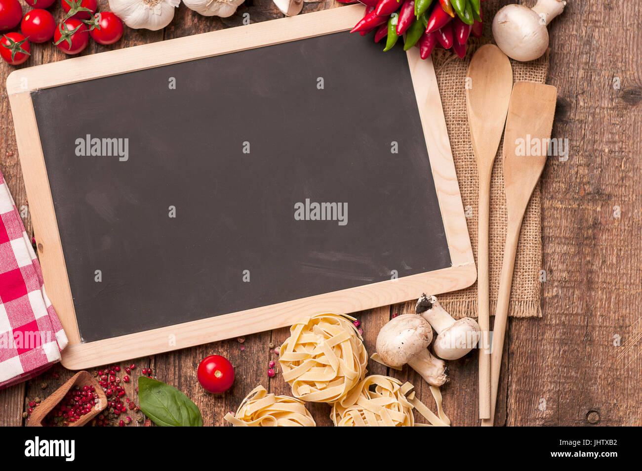 Pasta cooking background with chalkboard, tomatoes, basil and olive oil ...
