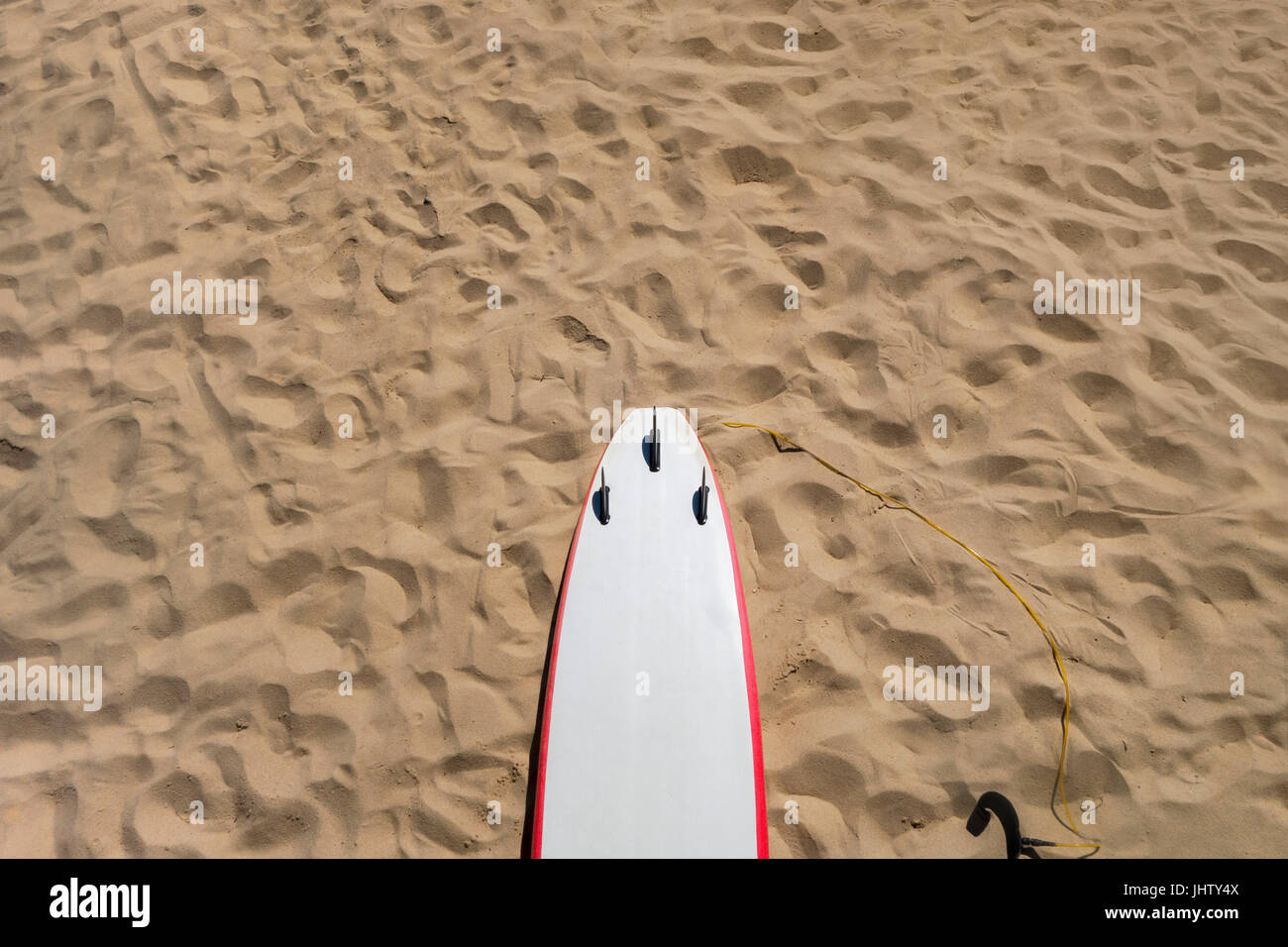bottom back of Surfboard on sand with foot step marks Stock Photo - Alamy