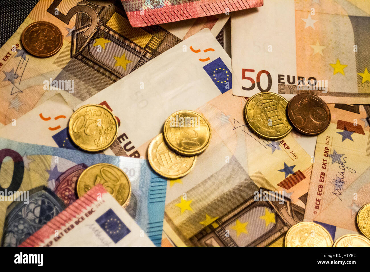 A composition of euro banknotes and coins providing great options to be ...