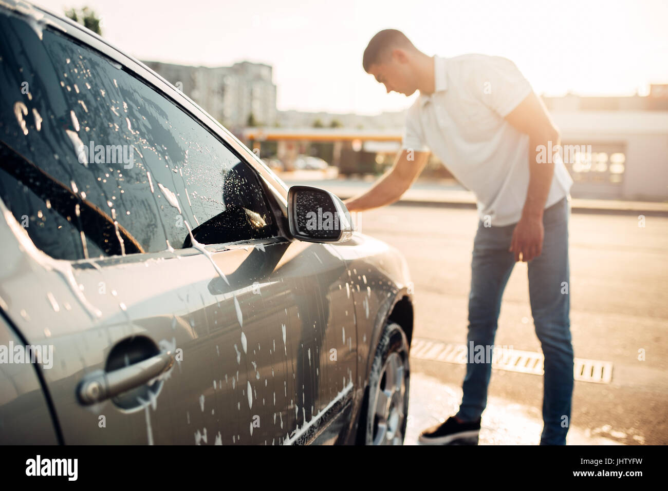 Washer rubbing vehicle with foam, automobile in suds, car wash ...