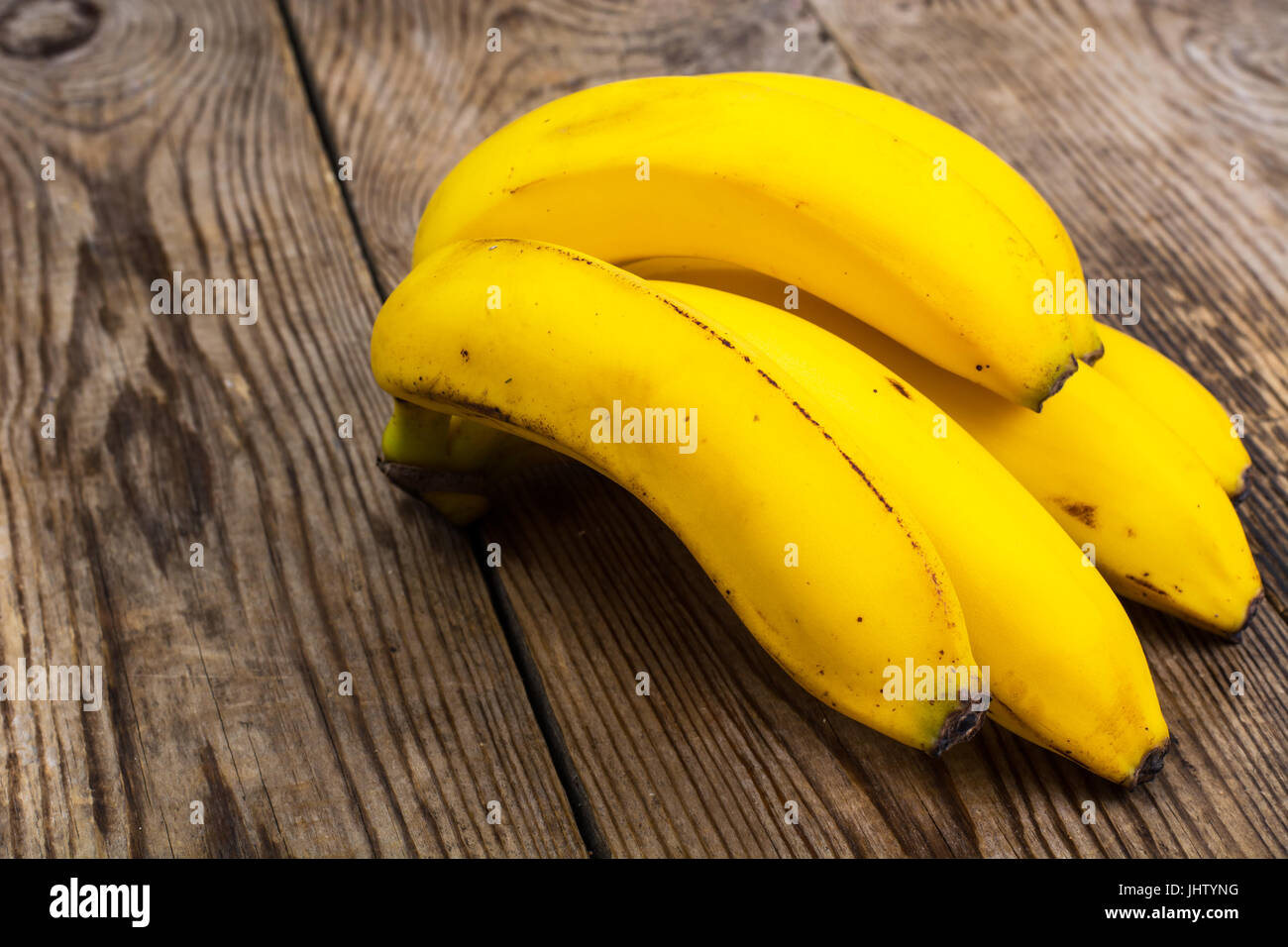 Bunch of bananas on old gray boards. Studio Photo Stock Photo - Alamy