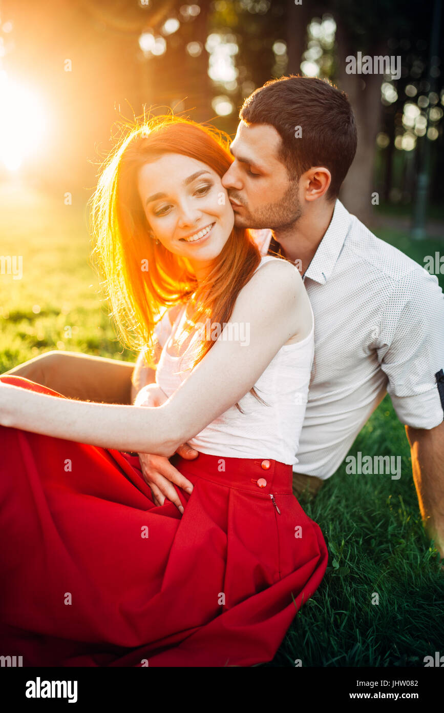 Love couple kissing in summer park on sunset. Romantic date of ...