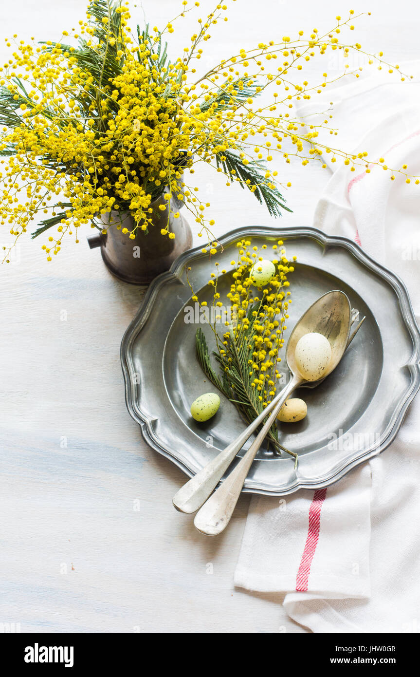 Festive table setting for Easter dinner with bright easter eggs and ...