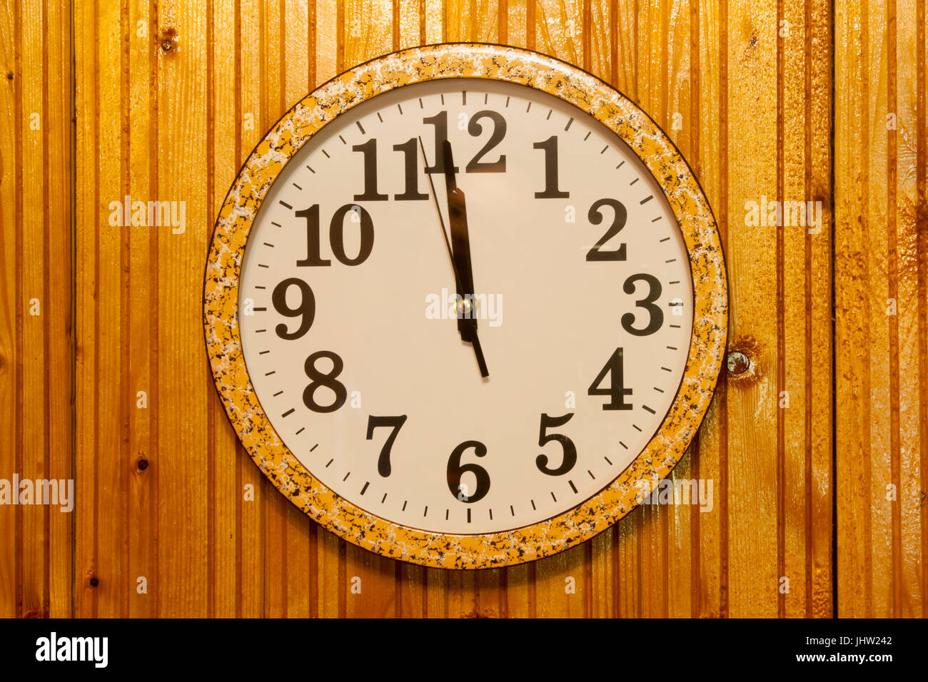 clock on wooden wall shows midnight Stock Photo - Alamy