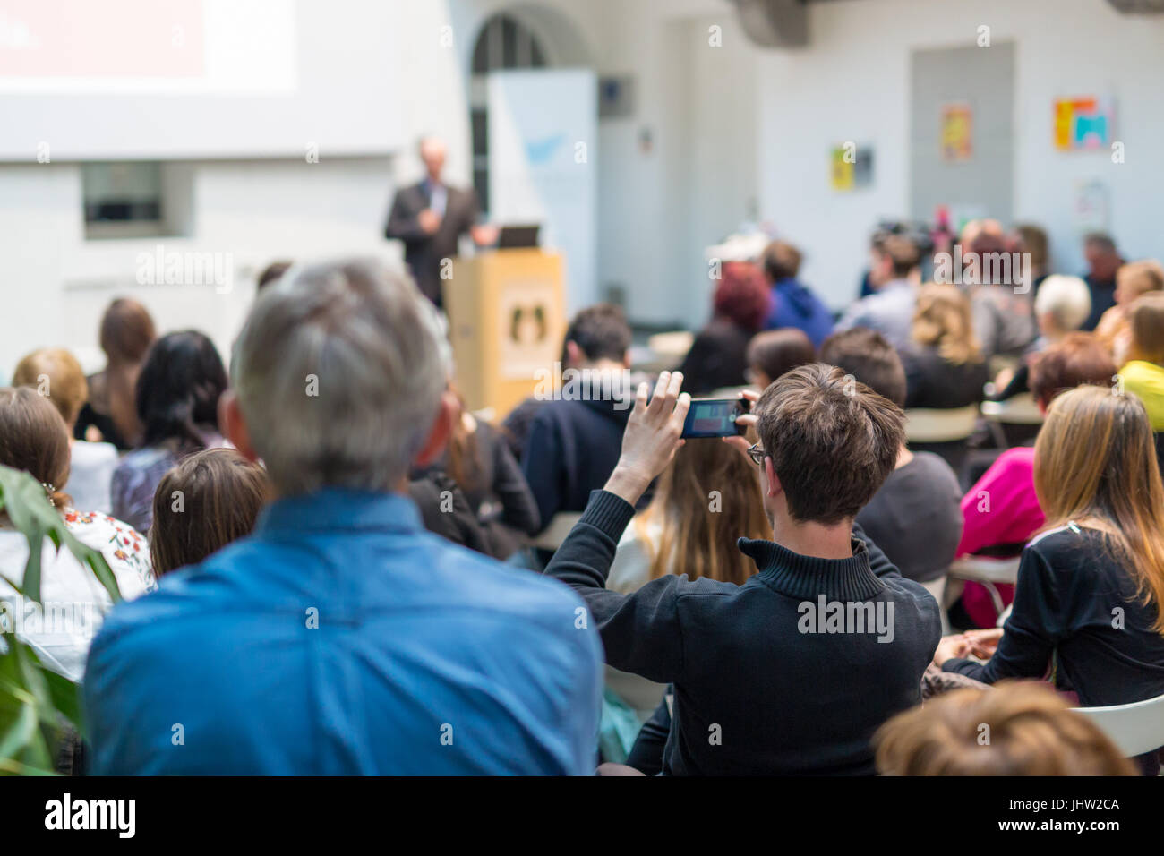 Man giving presentation in lecture hall at university Stock Photo - Alamy