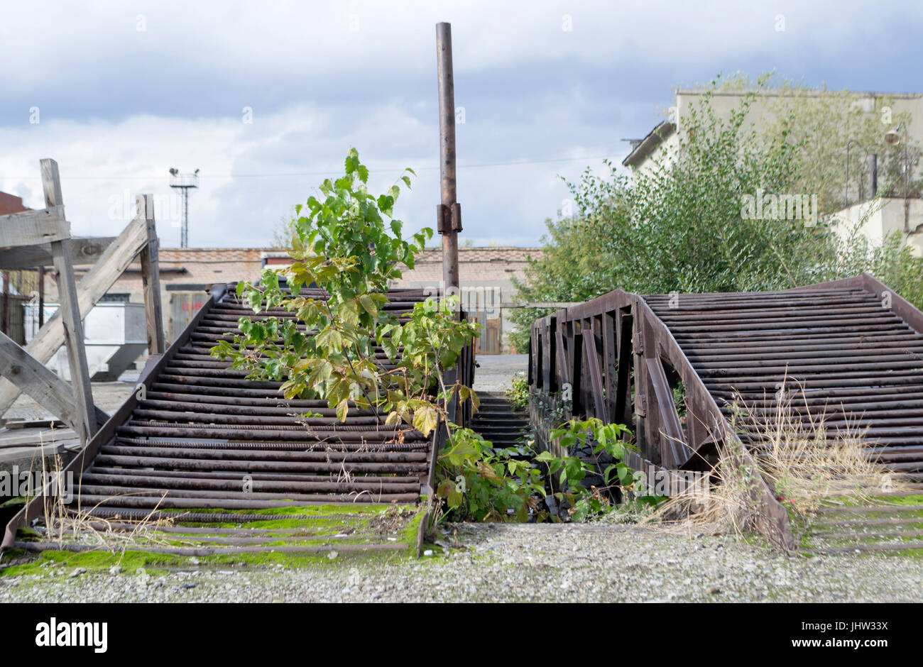 Old abandoned factory area with green tree in the foreground Stock ...