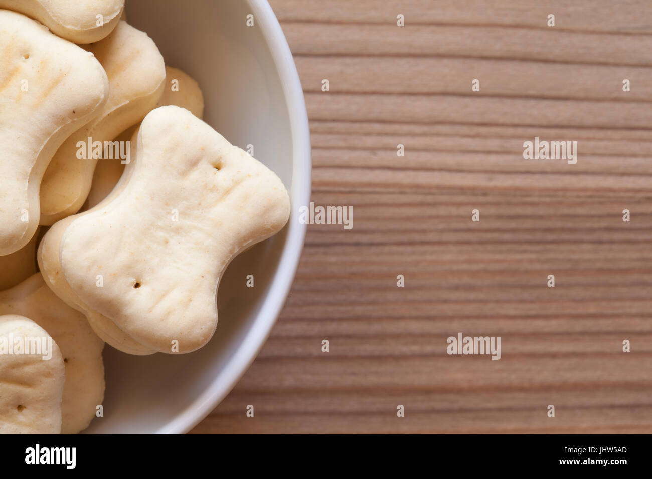 bone shaped dog cookies in a white bowl Stock Photo - Alamy