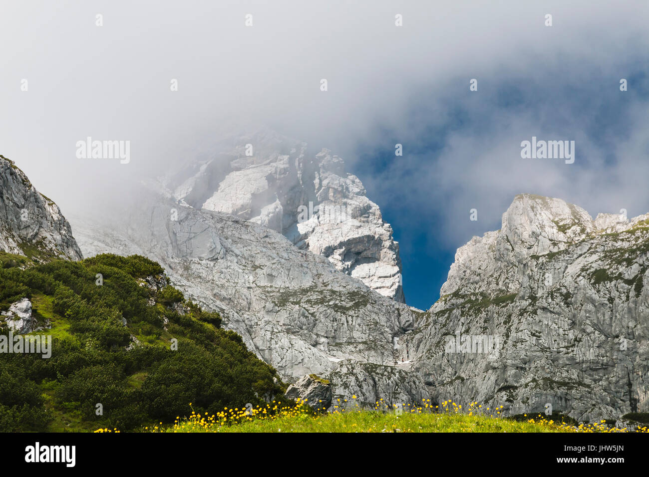 The rocky Alpspitze near Wetterstein with some fog in front of deep ...