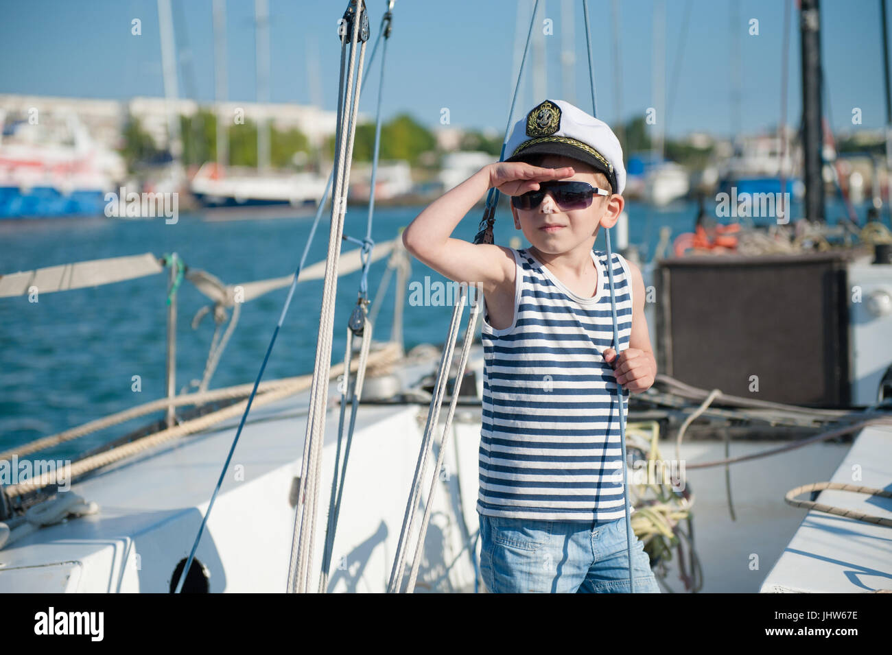 cute little boy captain wearing captain cap and sunglasses aboard ...