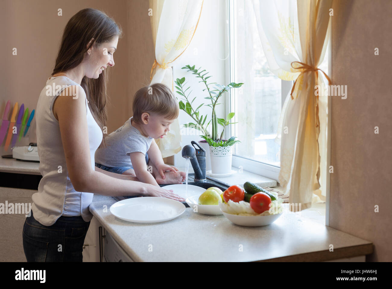 kitchen mom son wash fruits and vegetables Stock Photo - Alamy