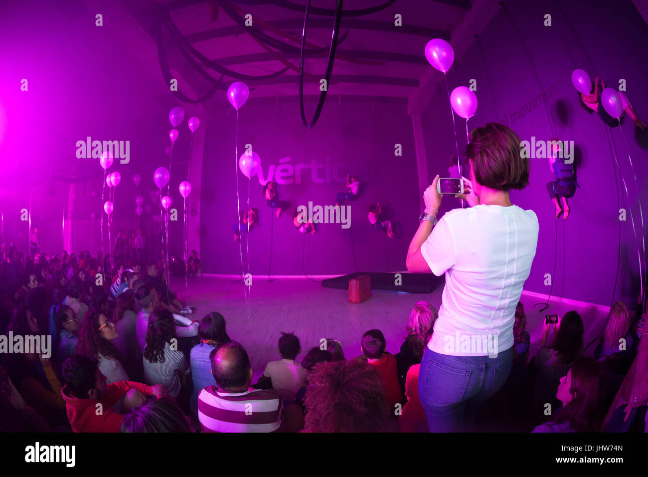 acrobats hanging on a rope by their legs Stock Photo - Alamy